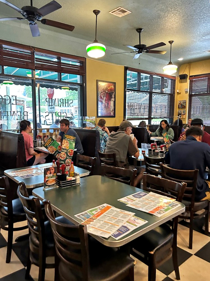 Inside, yellow walls and ceiling fans create that perfect "stay awhile" atmosphere where coffee refills flow as freely as conversation.