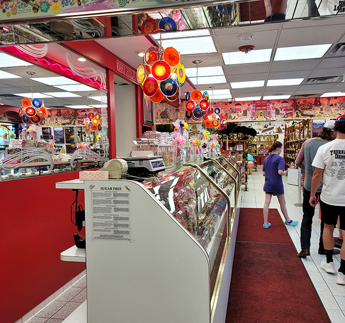 Colorful lollipop chandeliers dangle overhead like sugary solar systems, guiding visitors through a galaxy of confectionery delights.
