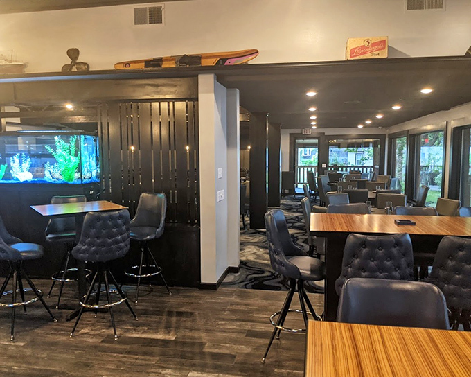 Modern meets cozy in this thoughtfully designed interior where an aquarium adds a splash of blue tranquility to the warm wood tones.