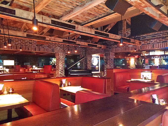 Red leather booths and exposed brick create that rare atmosphere where both first dates and business deals thrive equally well.