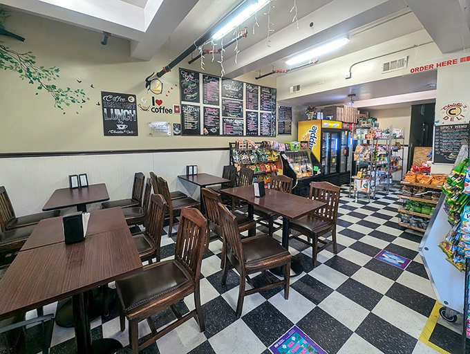 Classic black and white checkered floors set the stage for sandwich magic, where wooden tables await the weight of Philadelphia's finest handheld meals.