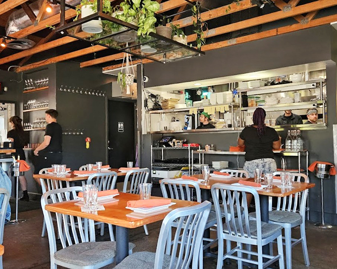 Industrial-chic meets cozy comfort inside Tinker Street, where wooden tables and open kitchen views create the perfect stage for culinary magic.