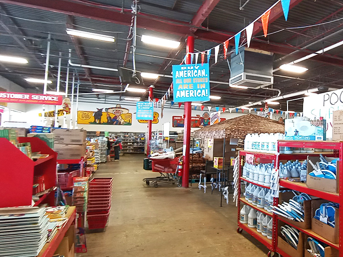 Colorful pennants and "American Made in America" signs hang from industrial ceilings, creating a carnival atmosphere for serious discount shoppers.
