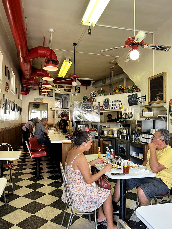 Inside Pop's, the checkerboard floor and red vinyl stools aren't retro by design&mdash;they're authentic by survival, creating a time capsule where breakfast dreams come true.
