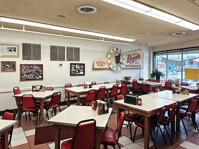 Simple tables, red chairs, and that clock reminding everyone: at Arthur Bryant's, it's always a good time for legendary barbecue.