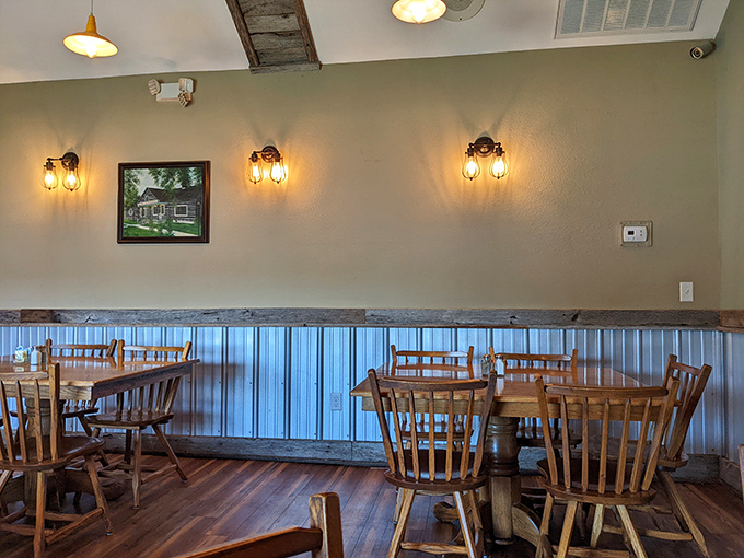 Wooden captain's chairs and corrugated metal wainscoting create that perfect "grandma's kitchen meets rustic retreat" atmosphere we all crave.