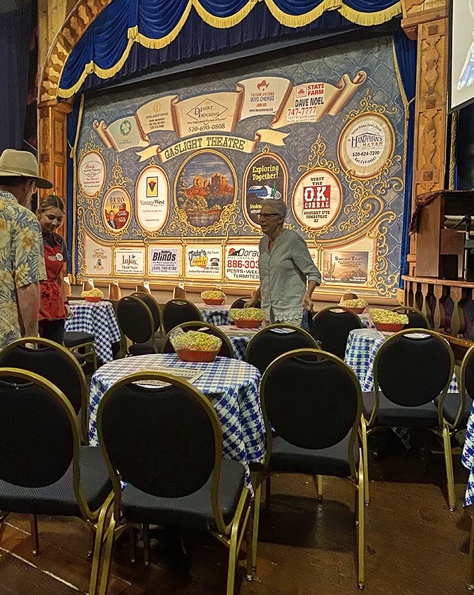 The Gaslight Theatre connection reveals itself with blue-draped elegance. Where dinner and show merge into one delightfully retro experience.