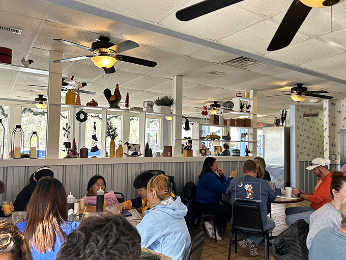 Inside, ceiling fans lazily spin above a bustling dining room where rooster decorations rule the roost. The packed tables tell you everything you need to know about the food quality.