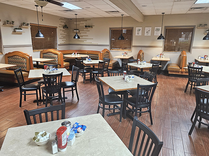 The dining room's warm wood tones and comfortable booths invite you to settle in. Notice the pendant lights &ndash; not trying to be trendy, just doing their job illuminating countless happy meals.