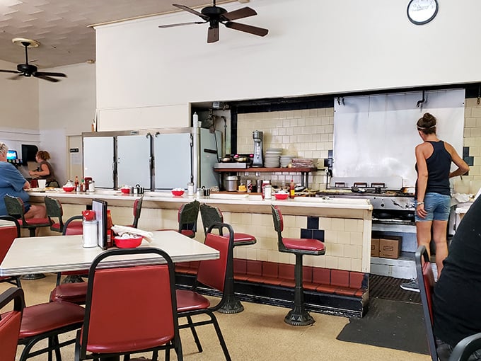 Where breakfast dreams come true &ndash; red vinyl stools, ceiling fans spinning lazily overhead, and the sizzle of a well-seasoned grill that's seen more sunrises than most residents.