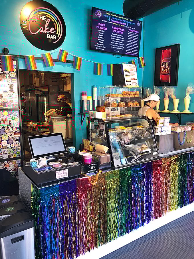 Step inside and the turquoise walls hit you like a Caribbean vacation. That rainbow tinsel counter is what Studio 54 would look like if it served cake.