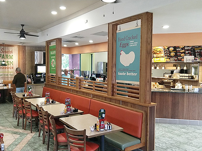 Inside, the orange booths and wooden accents create that perfect sweet spot between fast-casual efficiency and "stay awhile" comfort.