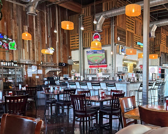 Wooden paneling and orange pendant lights create that perfect "where everybody knows your name" vibe. Comfort food deserves a comfortable setting.