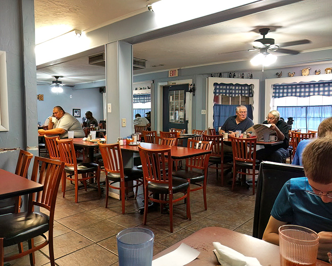 Inside, wooden chairs and blue-checked curtains create that perfect "grandma's dining room" atmosphere where calories don't count and conversations flow freely.