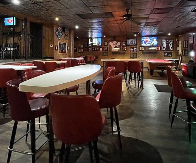 Classic tavern vibes with wood paneling, red chairs, and pool tables in the back &ndash; the universal language of "you're among friends here."