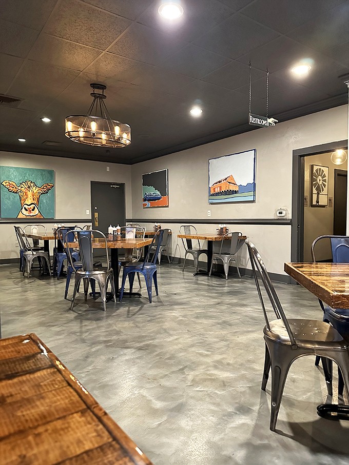 Industrial-chic meets Southern comfort in this dining room, where that colorful cow painting seems to say, "You're welcome for my sacrifice."