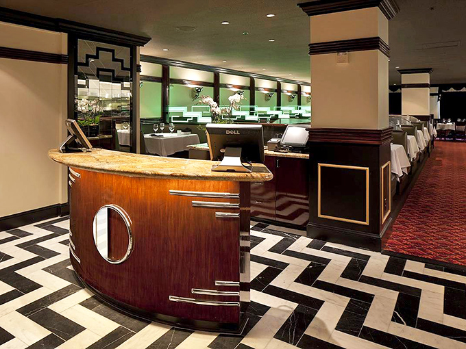 Art Deco meets modern luxury with that stunning chevron floor and curved reception desk—the kind of entrance that makes you stand a little straighter.