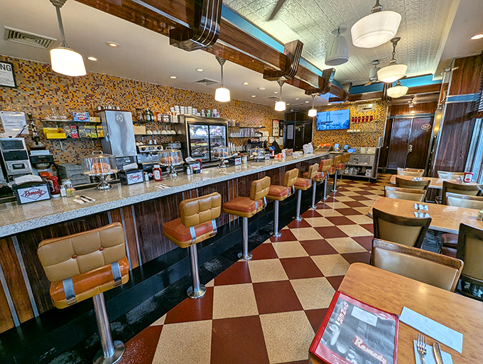 Classic checkered floors and tangerine vinyl stools—this isn't interior design, it's time travel with the bonus of someone cooking for you.