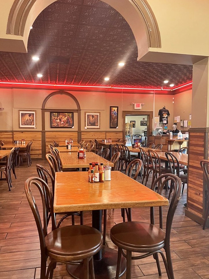Warm wood paneling and that distinctive red ceiling glow create an atmosphere that says "stay awhile" before your food even arrives.