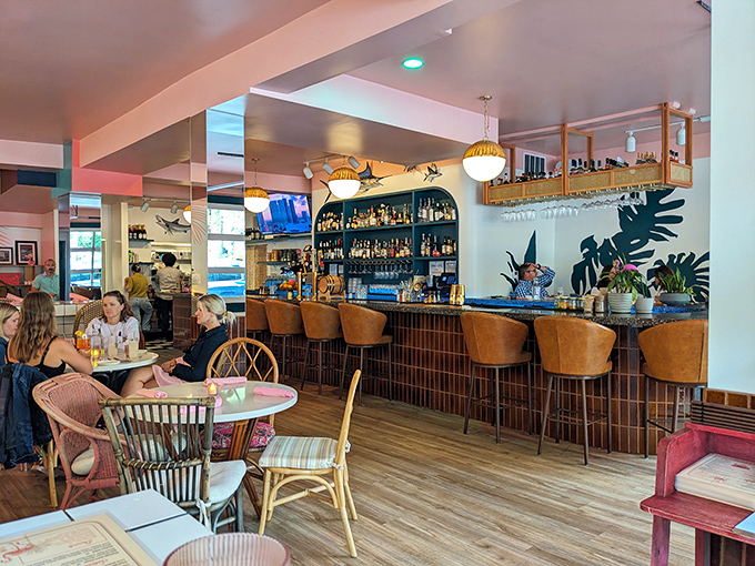 Not just a bar, but a sanctuary of spirits where warm wood tones and lush plants create the perfect backdrop for liquid artistry.