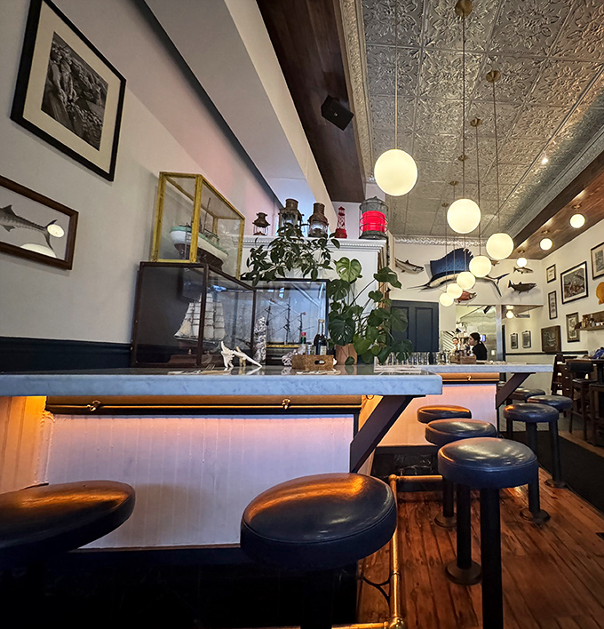 Pressed tin ceilings, globe pendant lights, and nautical touches create that rare atmosphere that's both sophisticated and comfortable&mdash;like a fisherman's tale you actually want to hear.