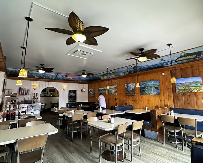 Inside, coastal charm meets diner comfort with wood paneling, ocean murals, and those distinctive leaf-shaped ceiling fans. It's California casual perfection.
