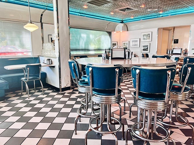 Step back in time with this quintessential diner interior &ndash; turquoise vinyl stools, checkered floors, and all. Somewhere, the Fonz approves.