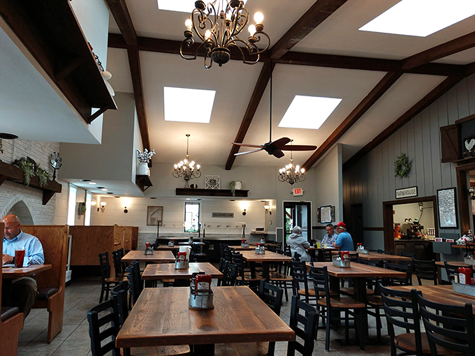 Exposed wooden beams and skylights create a space that's both airy and intimate. Somewhere between farmhouse chic and your favorite aunt's dining room.