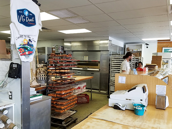 Behind these racks lies the magic factory where flour transforms into happiness, one perfectly proofed ring at a time.