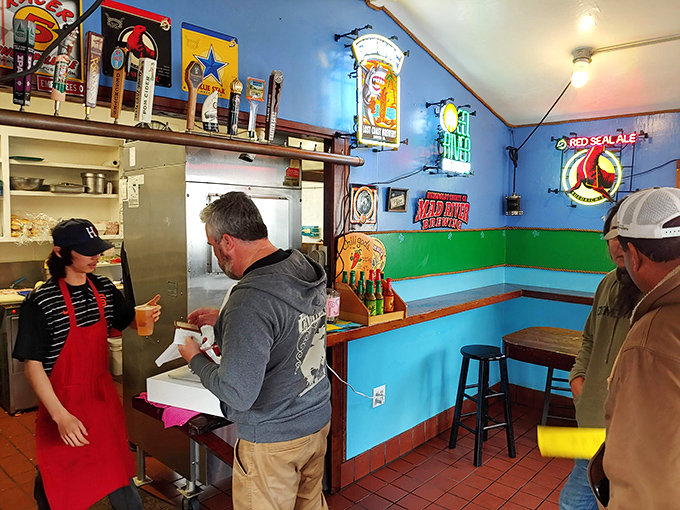 Vibrant blue walls and beer signs create the perfect backdrop for seafood magic. This isn't d&eacute;cor&mdash;it's a promise of coastal authenticity.