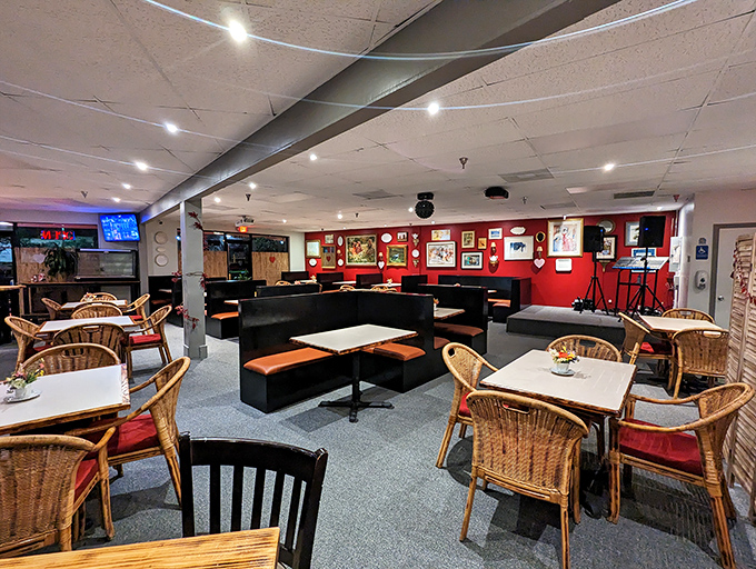 Where comfort food meets unexpected elegance – those wicker chairs and red walls create the perfect backdrop for wing worship.