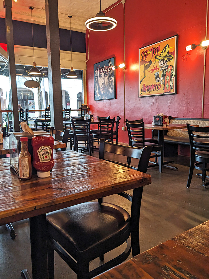 Warm red walls, wooden tables, and eclectic art create the perfect backdrop for the impending food euphoria.