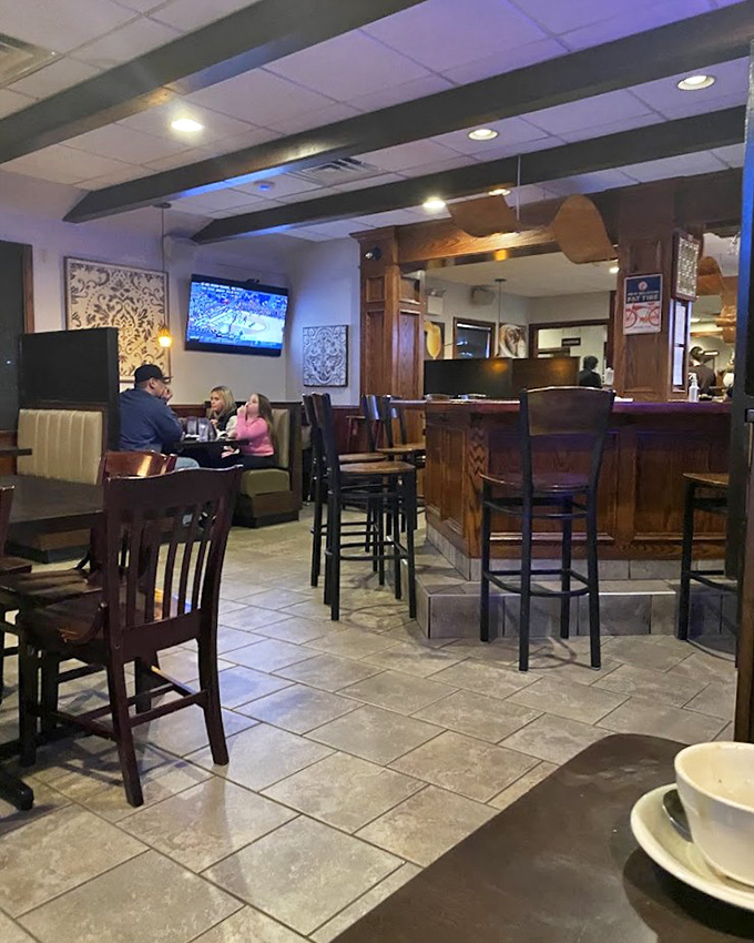That interior shot reveals a dining room where countless stories have unfolded over perfectly broiled cheese.