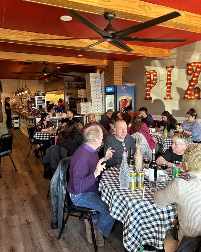 Where checkered tablecloths and illuminated pizza signs create the kind of ambiance money can't buy.