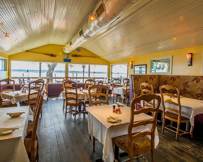 Sunlight streams through windows framing waterfront views that rival the food for attention. Dining rooms with a view? This one's practically floating. 
