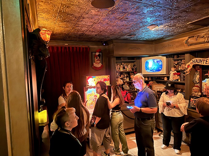 In this dimly lit room of vintage oddities, visitors huddle together like penguins in Antarctica—safety in numbers against the supernatural.