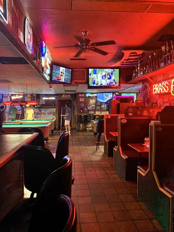 Step inside and you're transported to a classic sports bar where the neon glow, pool tables, and multiple TVs create the perfect backdrop for burger bliss.