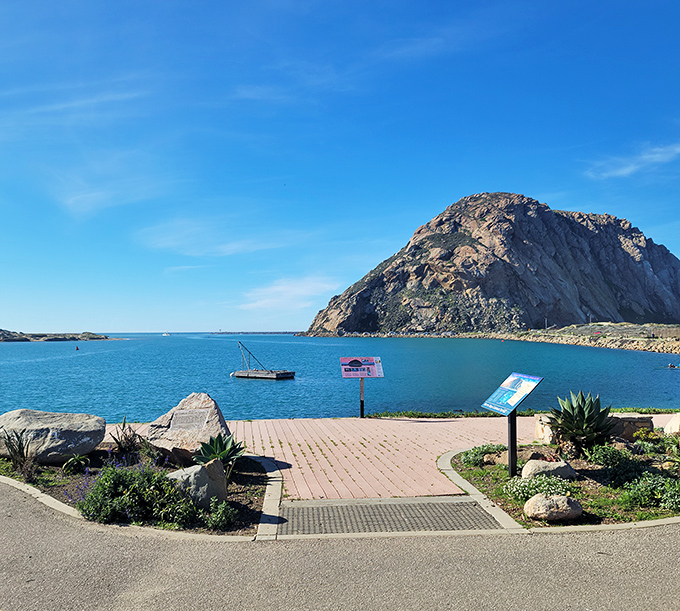 The iconic rock meets the tranquil bay, creating a postcard-perfect scene that no filter could possibly improve upon.