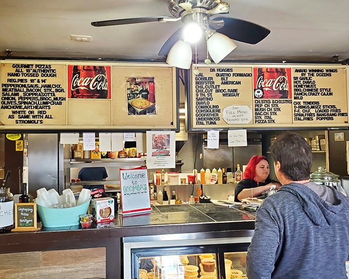 The menu board tells stories of Italian-American culinary magic, with "Da Hoagies" section reading like poetry to sandwich enthusiasts.