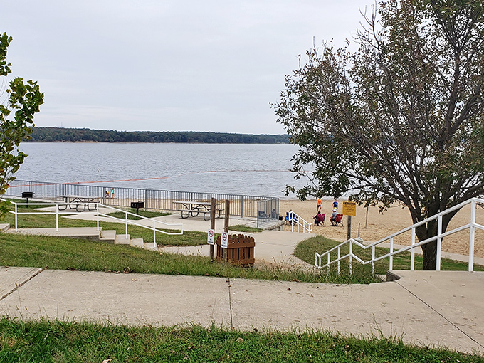 The path to relaxation is paved with concrete steps and sandy shores. Nature's amphitheater awaits at the water's edge.