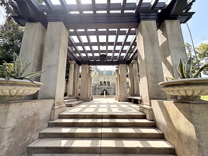 Framing perfection: This pergola creates the ultimate reveal, drawing your eye toward the mansion like the world's most elegant "ta-da" moment.