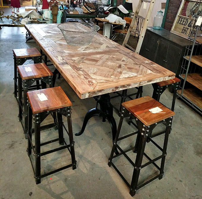 This industrial-chic dining table combines reclaimed wood with metal framework - perfect for the homeowner who wants dinner conversations with historical subtext.