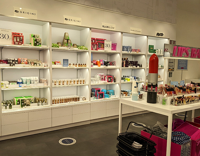 A beauty lover's dream landscape at the cosmetics outlet, where skincare salvation awaits those who've braved the desert air.