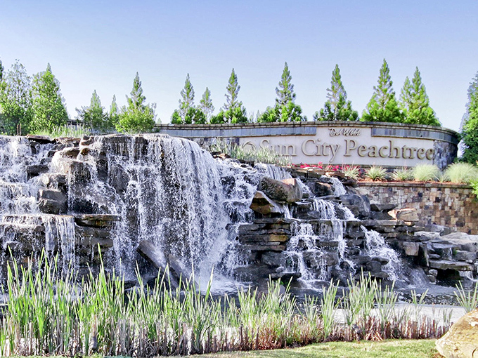Nature meets luxury at the community entrance. This cascading waterfall doesn't just say "welcome home"&mdash;it practically sings it with a full orchestra backing.