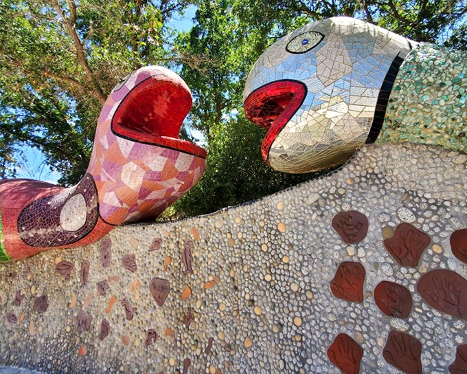 Like chatty neighbors leaning over a fence, these mosaic serpents seem caught mid-gossip, their vibrant patterns telling tales only art can translate.