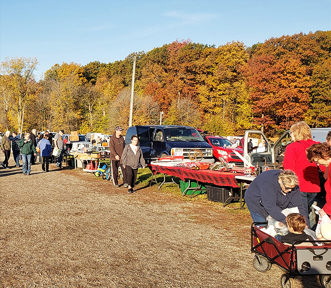 Fall's golden backdrop frames the treasure hunt, as shoppers navigate rows of tables where yesterday's memories become tomorrow's conversation pieces.
