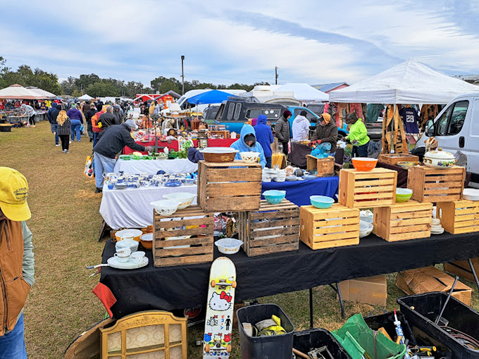 The modern bazaar in full swing. Wooden crates and colorful displays transform an ordinary field into a shopper's paradise of possibility.