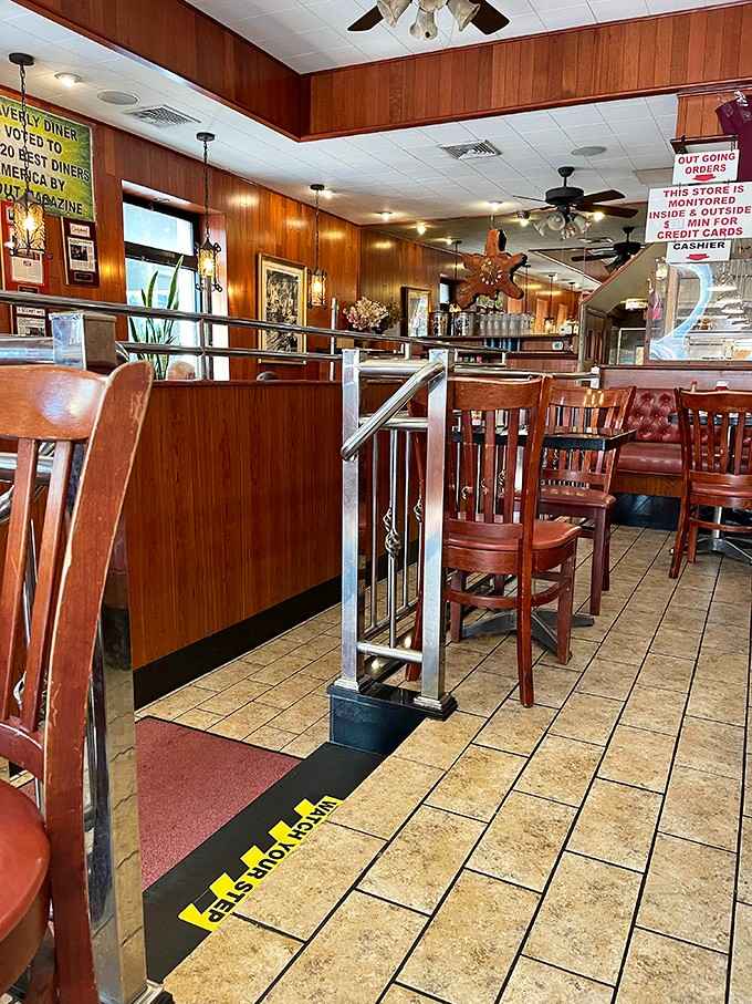 Wood-paneled warmth and red vinyl booths create the perfect diner atmosphere for memorable meals.