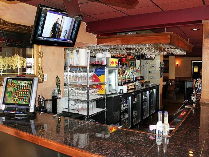 The welcoming bar area sets the stage for memorable meals, combining neighborhood charm with polished hospitality and impressive beverage selections.