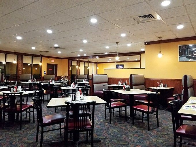 Step inside and those warm yellow walls practically wrap you in a hug, while burgundy booths promise conversations that last longer than planned.